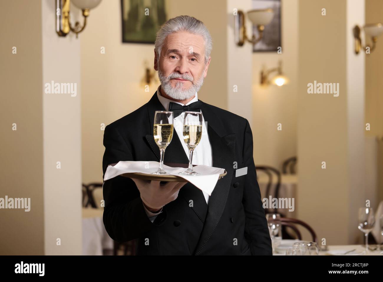 Senior waiter holding tray hi-res stock photography and images - Alamy