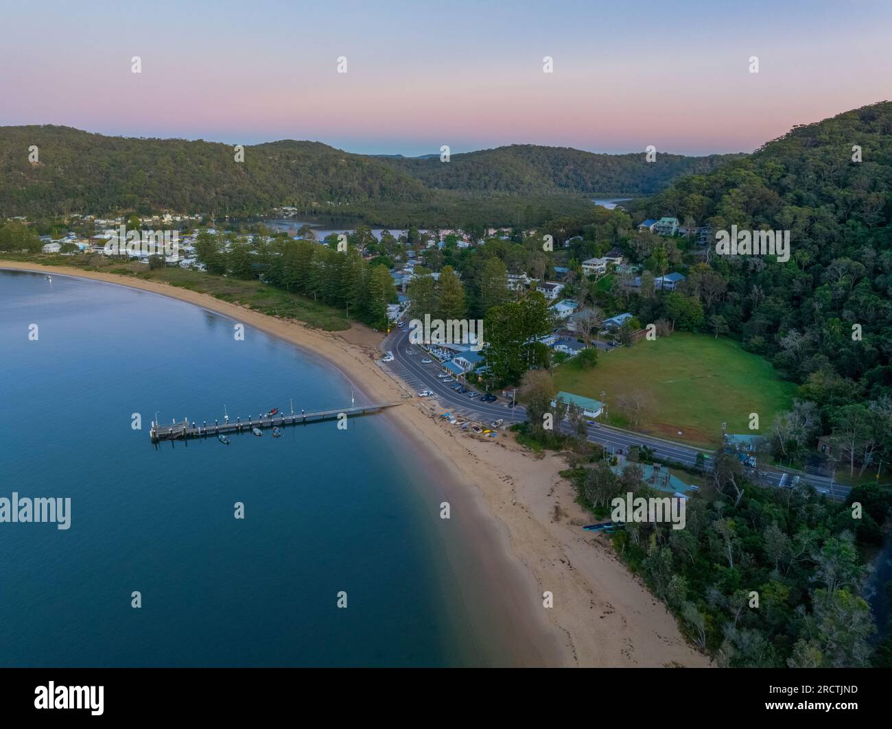 Sunrise over Brisk Bay with boats and mountain ranges around the ...