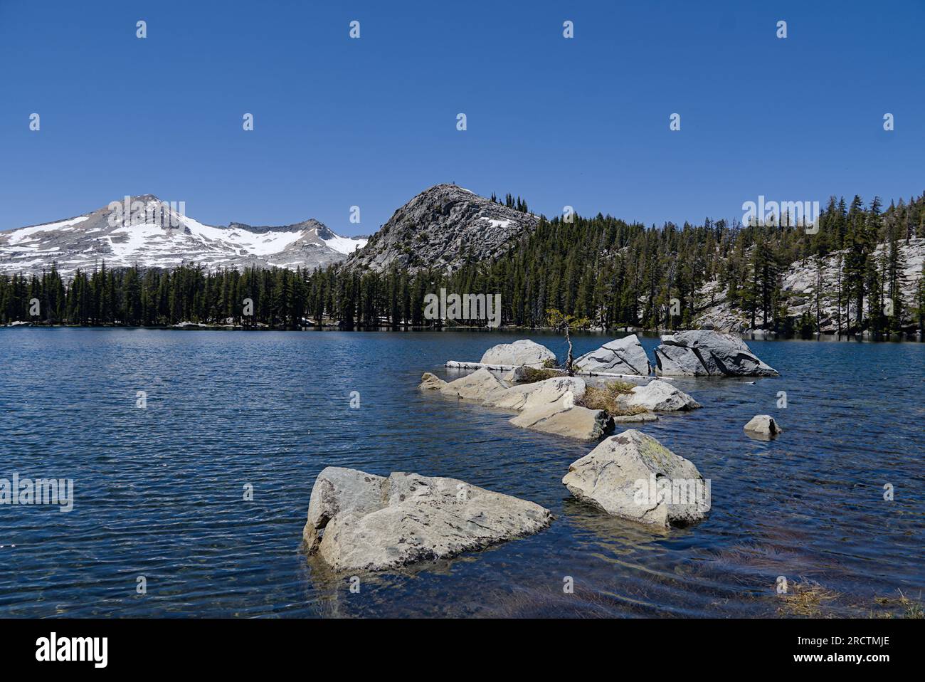 Lake Aloha with boulders in the blue water and surrounded the alpine ...