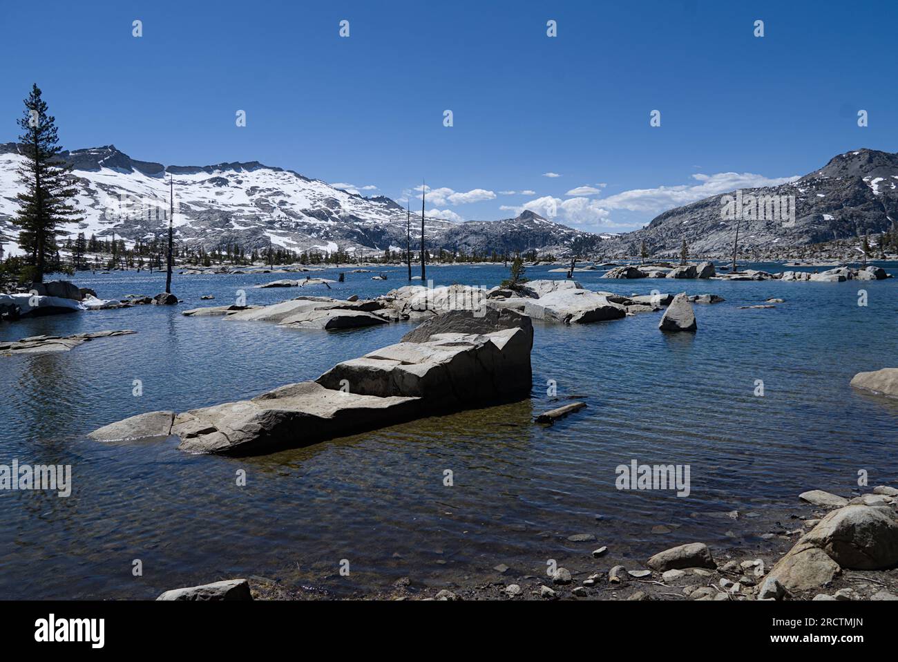 Lake Aloha with boulders in the blue water and surrounded the alpine ...