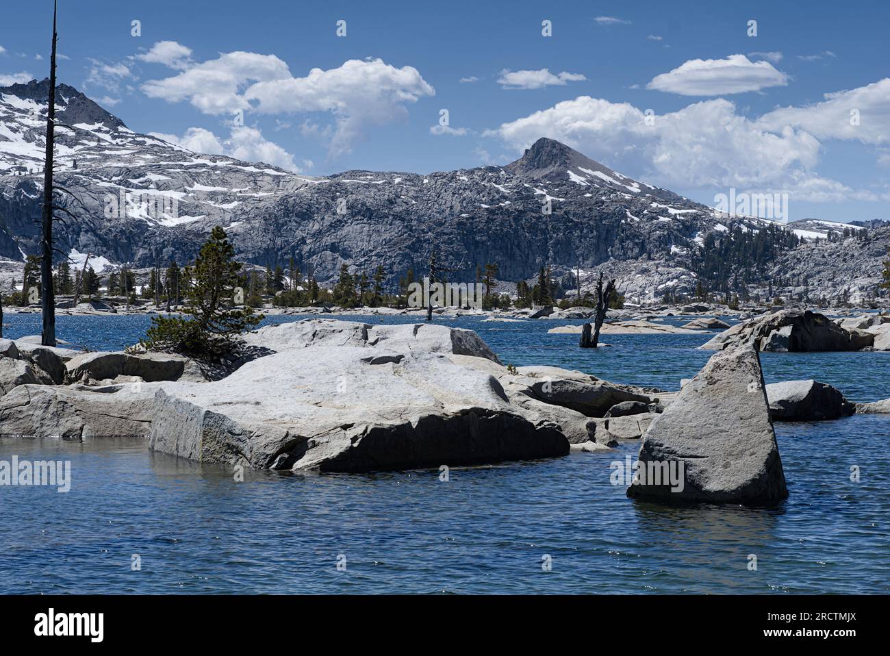Lake Aloha with boulders in the blue water and surrounded the alpine ...