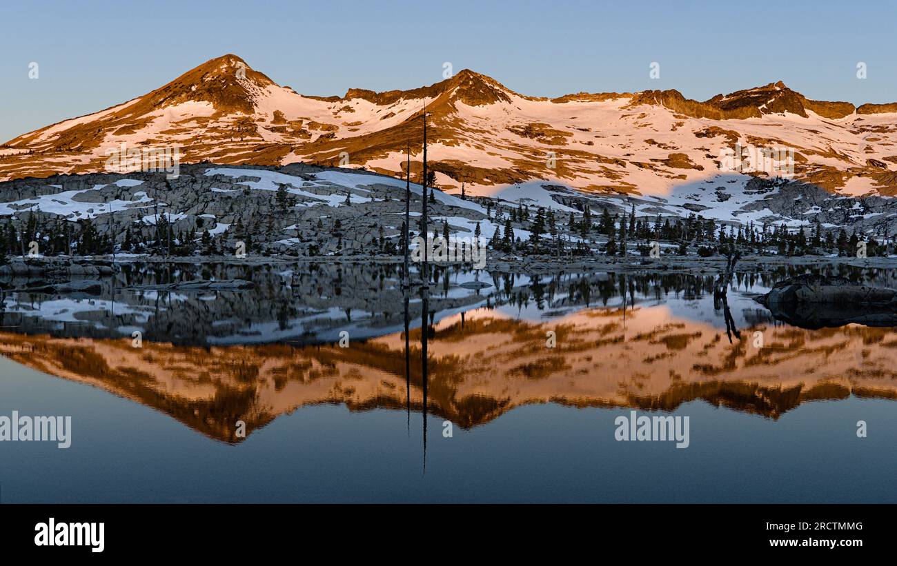 Alpine mountains covered with snow lighted up by the morning sunlight ...