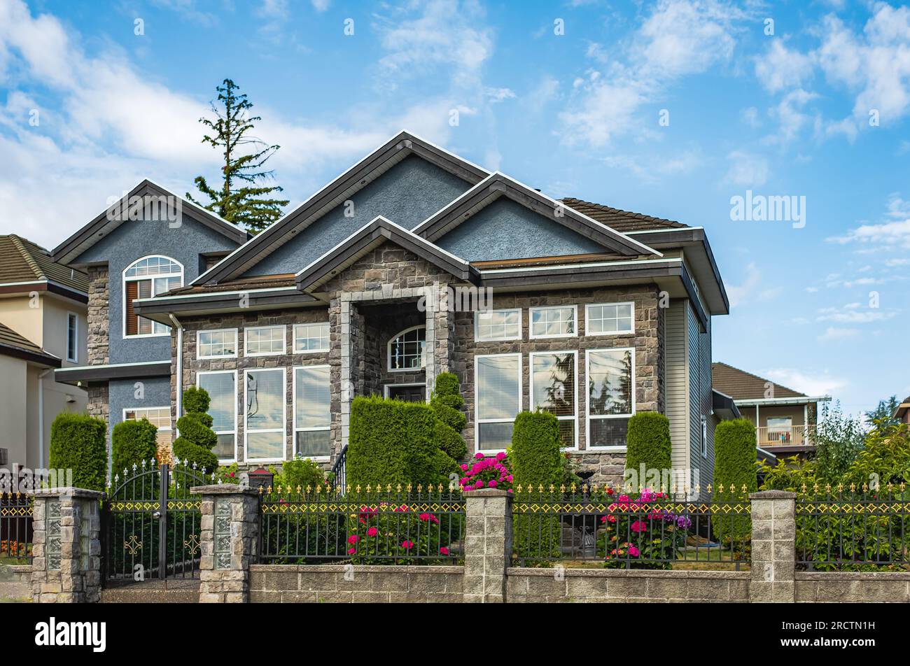 Real Estate Exterior Front House on a sunny day. Big custom made luxury ...