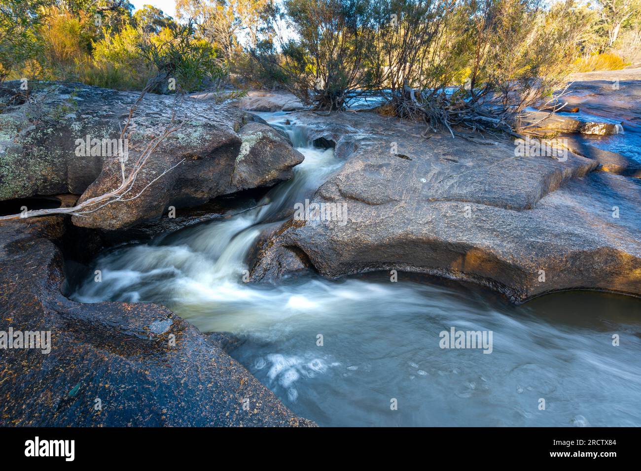 Water cascading over granite rock bed, Bald Rock Creek, Girraween ...