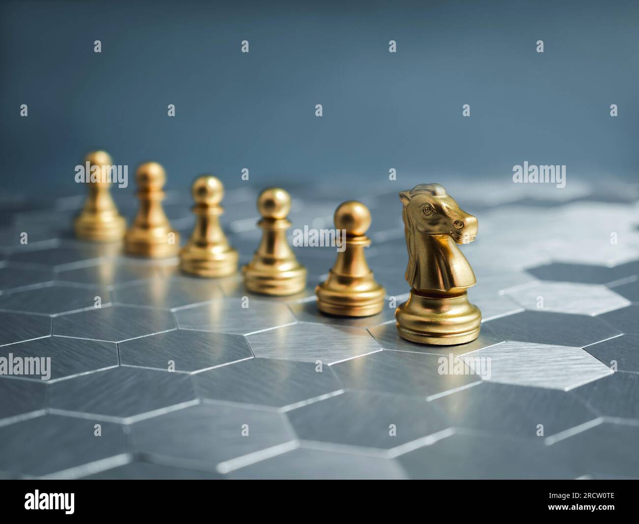 The golden horse, knight chess piece standing front of gold pawn chess ...