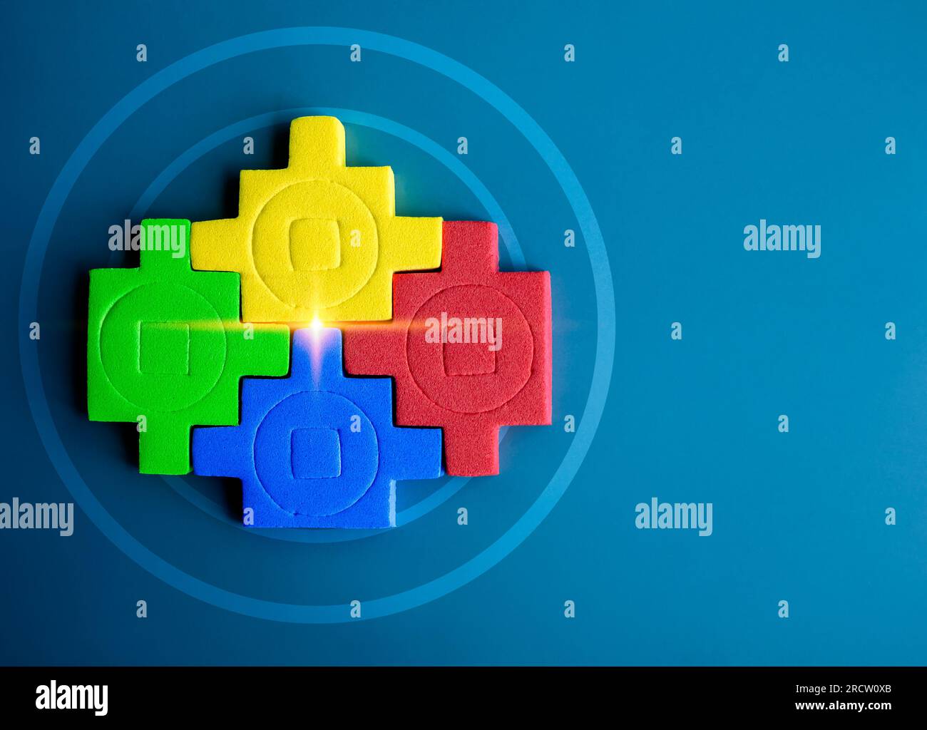 Four jigsaw puzzle blocks different colors are put together perfect on ...