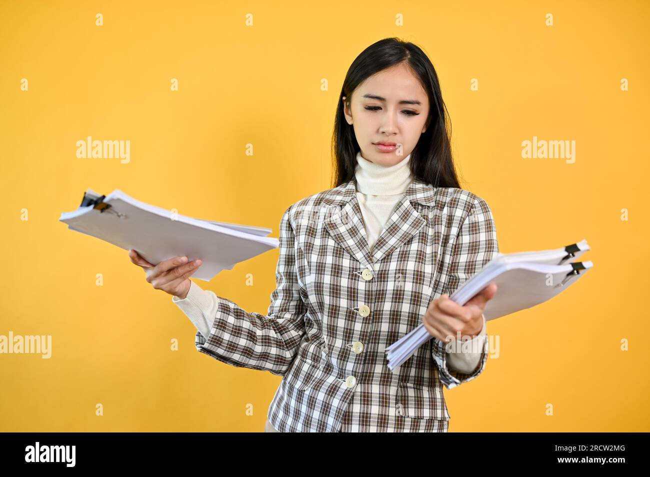 A confused and perplexed young Asian businesswoman looking nat ...
