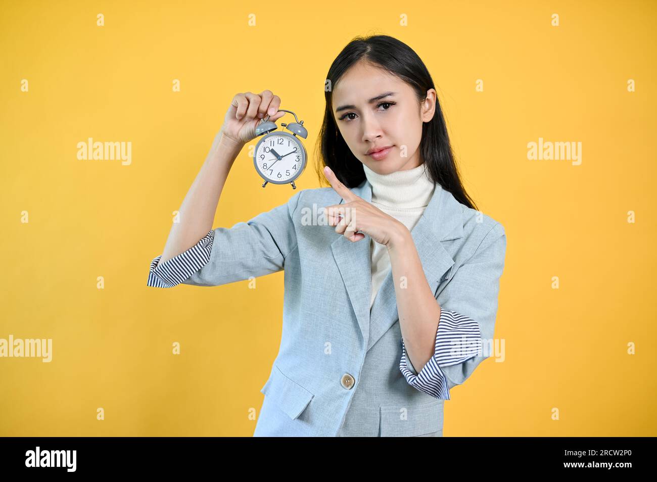 A serious and strict Asian businesswoman pointing her finger at an ...