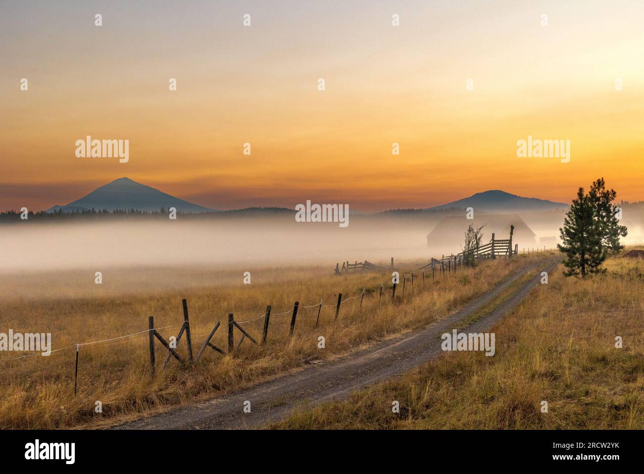 Misty ground fog enhances a colorful sunrise scene of Mt McLoughlin, a ...