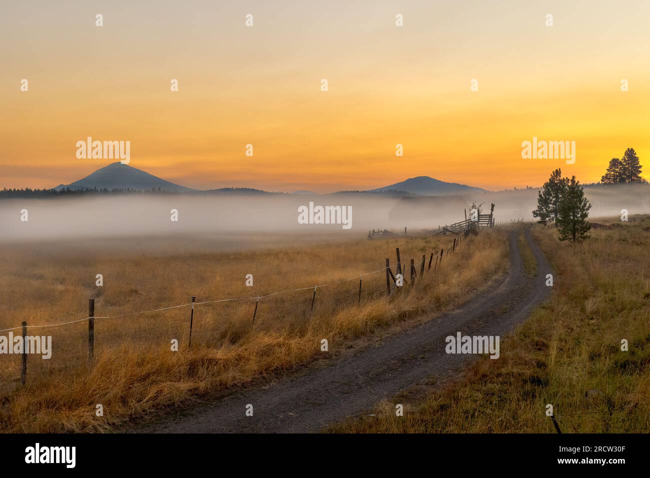 Misty ground fog enhances a colorful sunrise scene of Mt McLoughlin, a ...