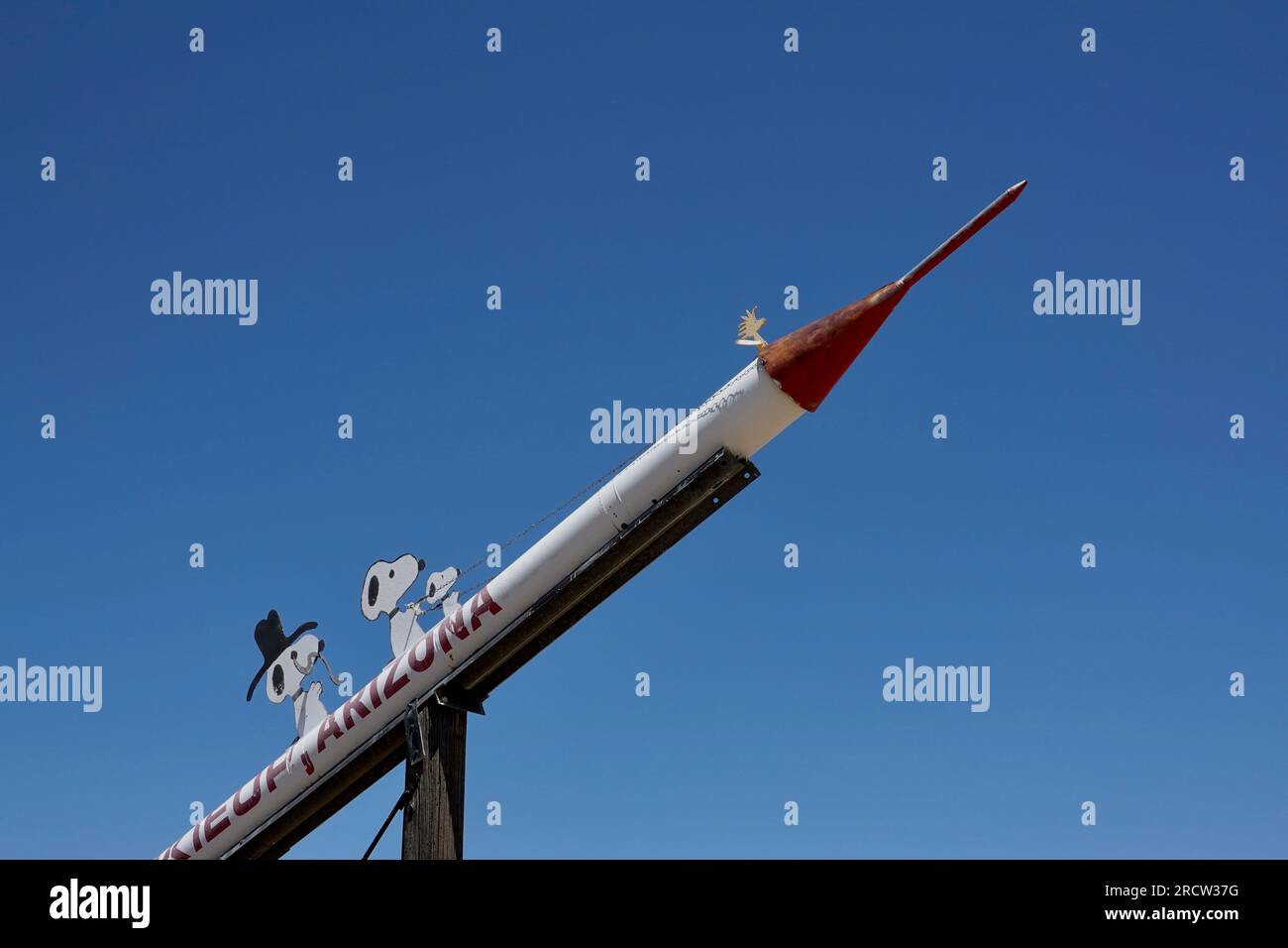 A roadway sign for the town of Wikieup, Arizona of a rocket with Snoopy ...