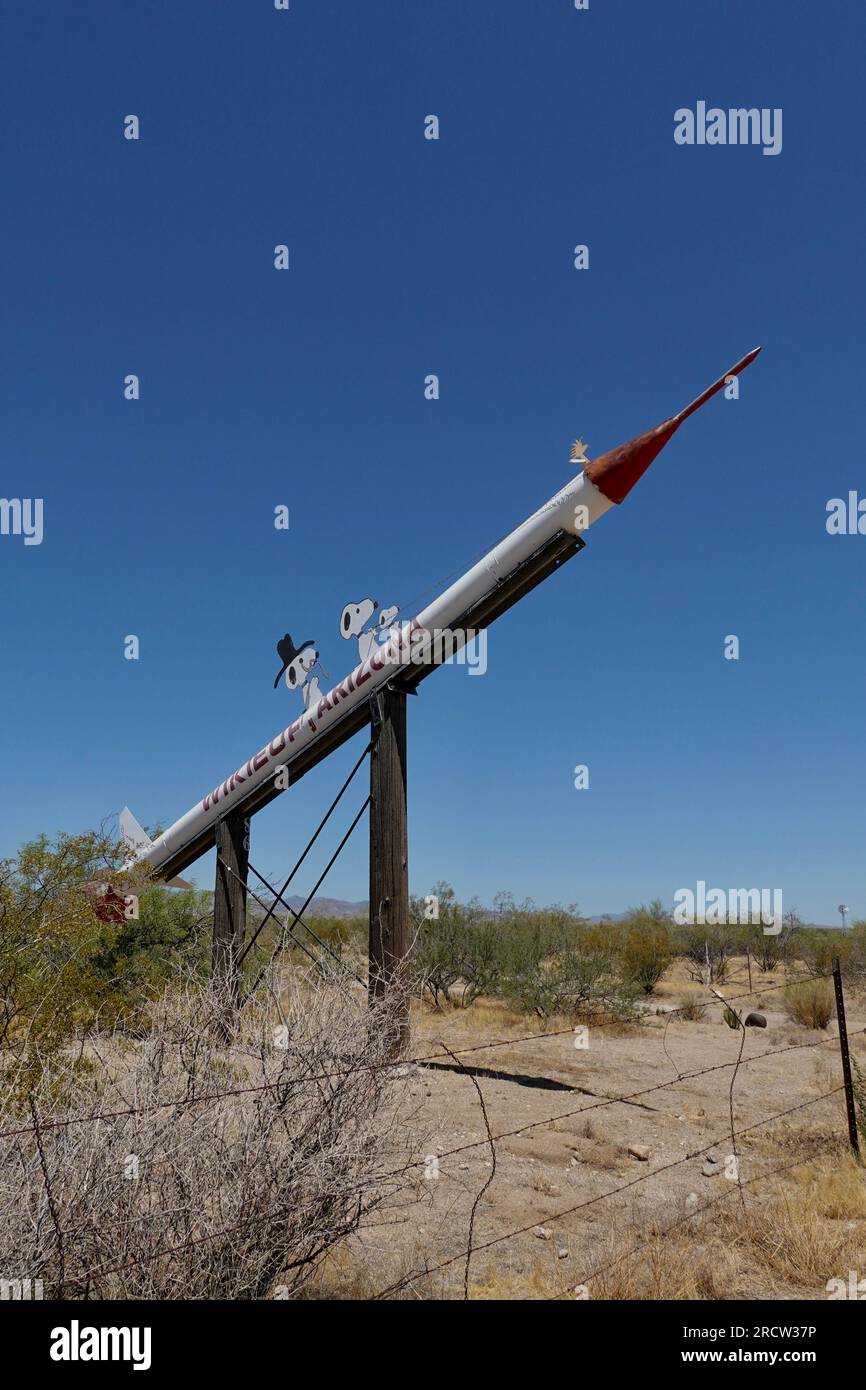 A roadway sign for the town of Wikieup, Arizona of a rocket with Snoopy ...