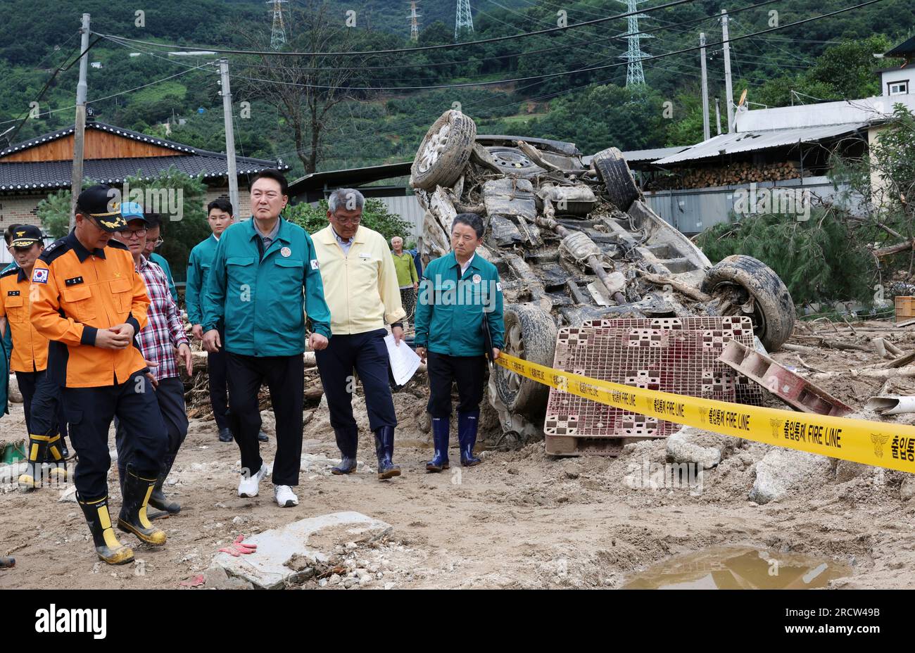 South Korean President Yoon Suk Yeol, fourth from left, looks around a ...