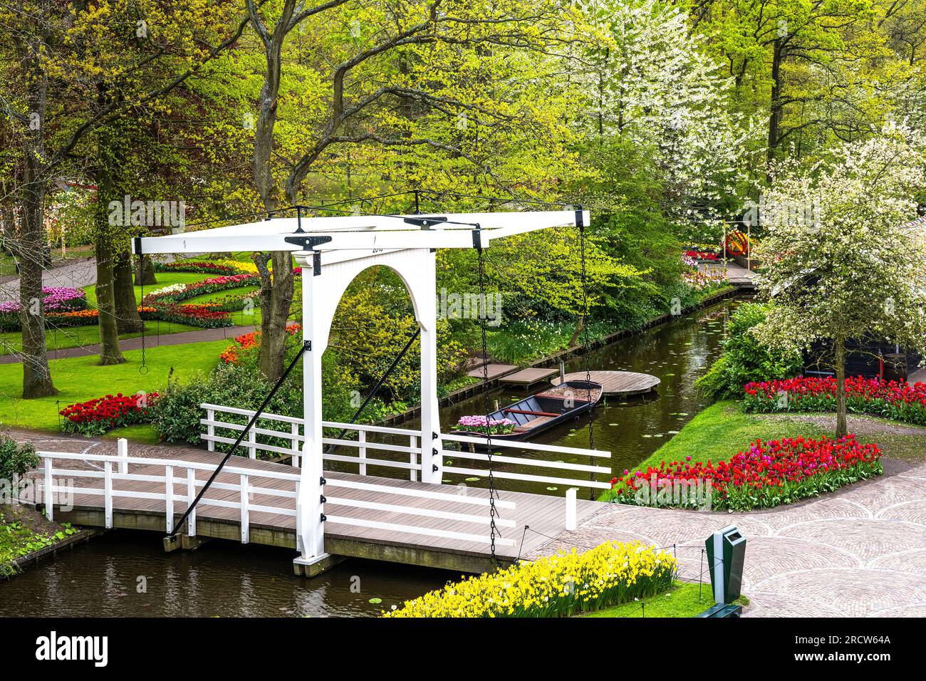high view of the white drawbridge and canal at the Keukenhof Gardens ...