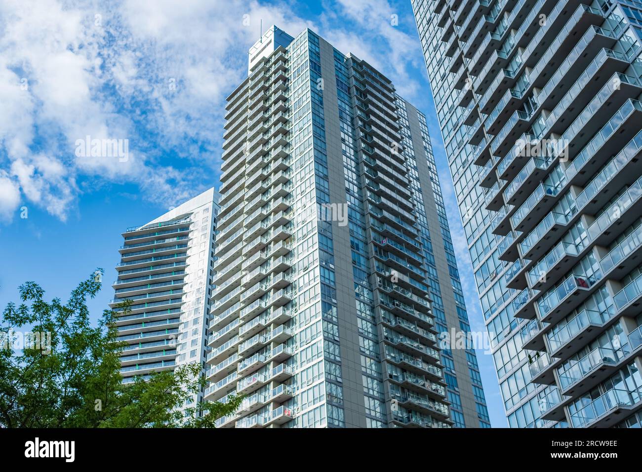 New block of modern apartments with balconies and blue sky in the ...