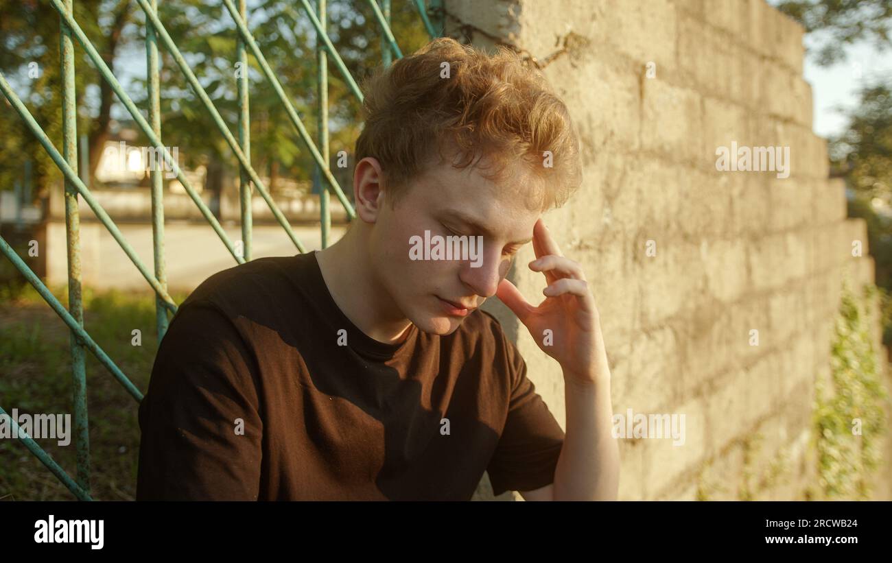 Overwhelmed by Stress: Blond Man Outdoors, Holding His Head and ...