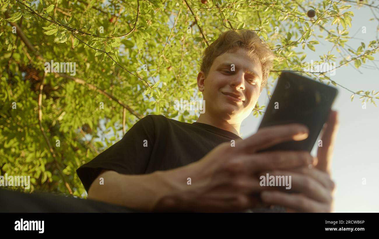 Mobile Connectivity: Handsome Young Blond Man Messaging or Using Mobile ...