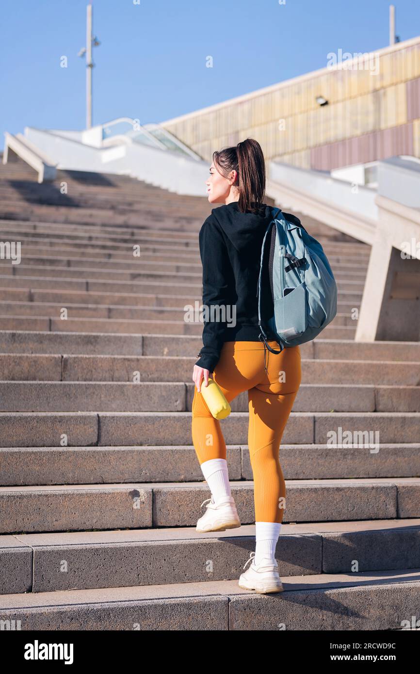 rear view of a sportive woman walking up stairs Stock Photo - Alamy