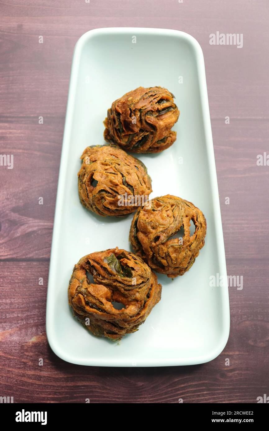 Dry Patra is an Indian dish made with colocasia leaves that are coated ...