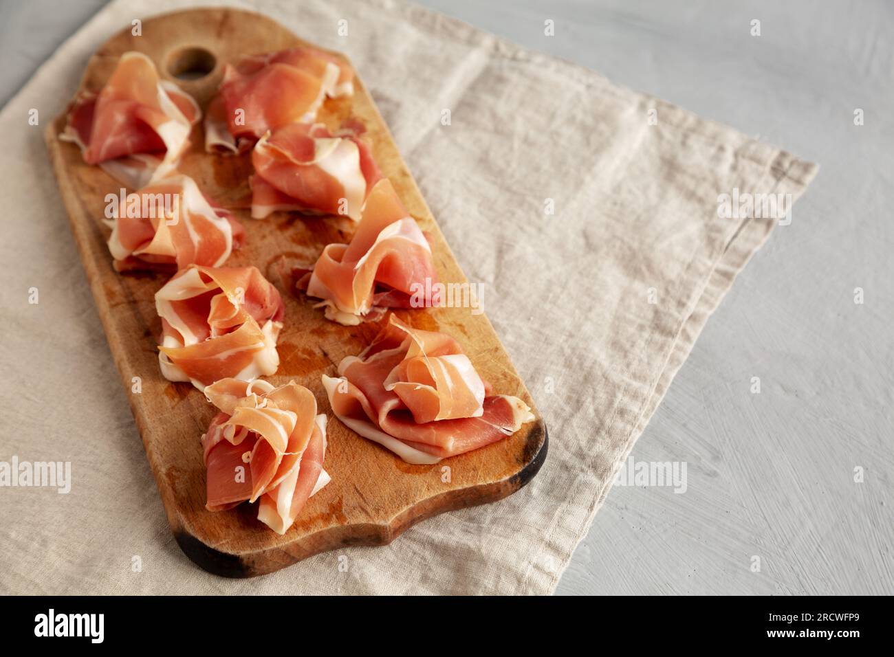 Slices of Appetizing Jamon Serrano Ready to Eat on a rustic wooden ...