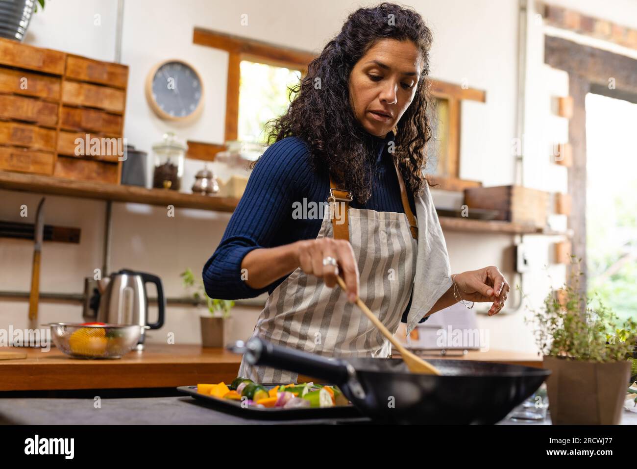 Woman wearing apron in kitchen hi-res stock photography and images - Alamy