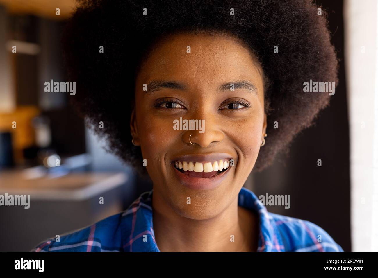 Portrait of happy african american woman with afro and nose ring ...