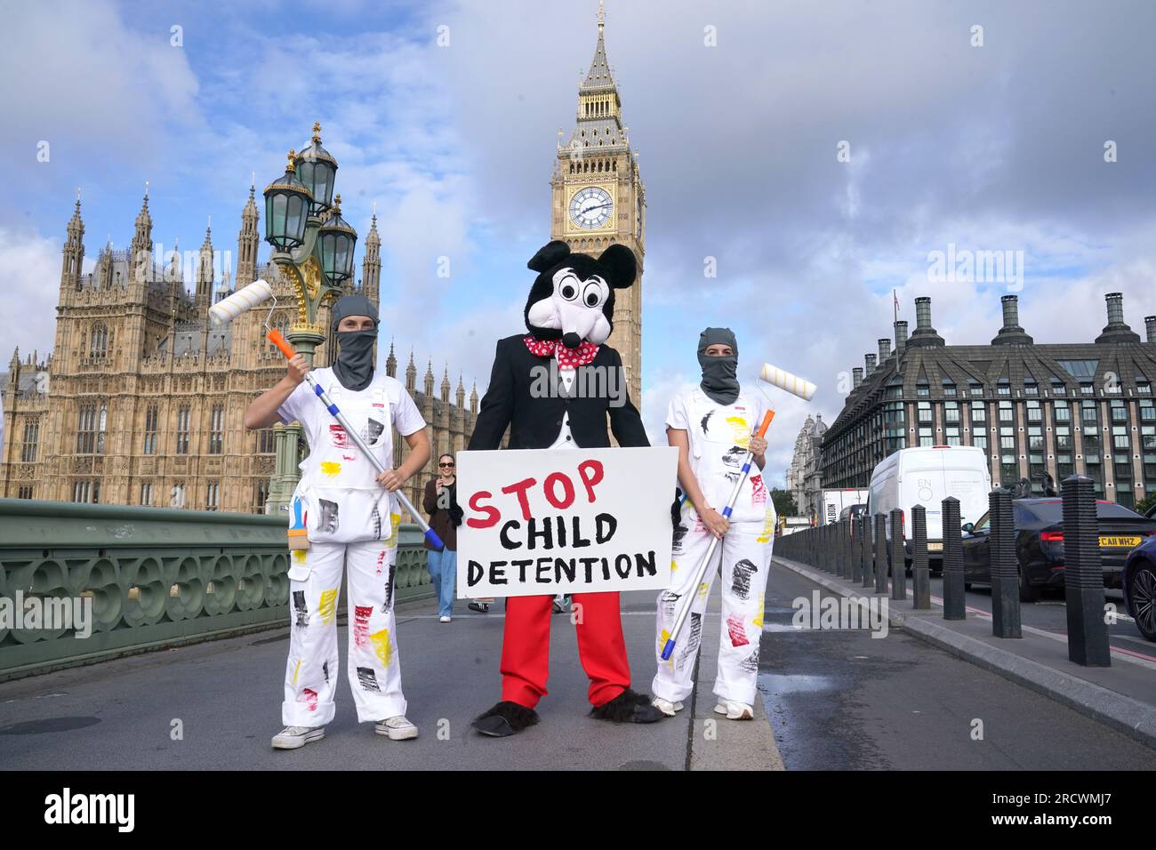 Comedian Dom Joly, dressed as Mickey Mouse, leads a Save the Children ...