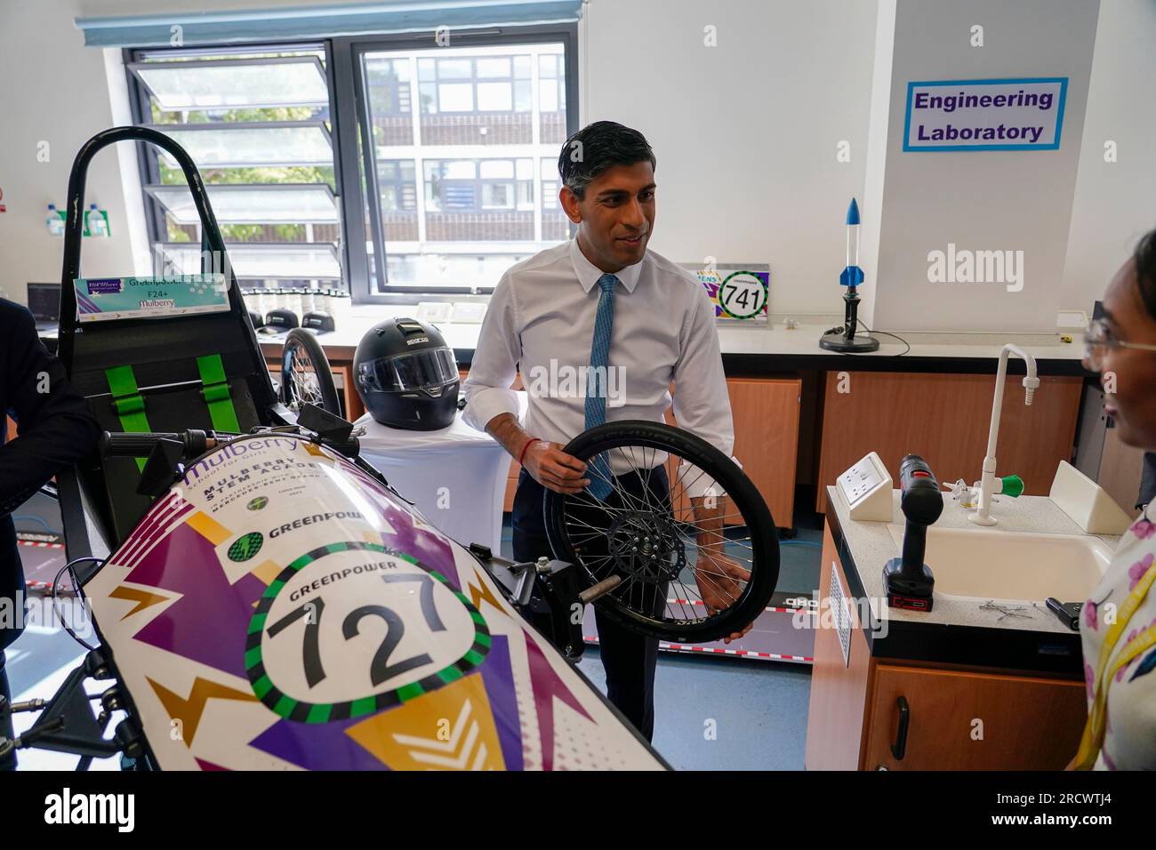 Britain's Prime Minister Rishi Sunak holds the tyre of a car prototype ...