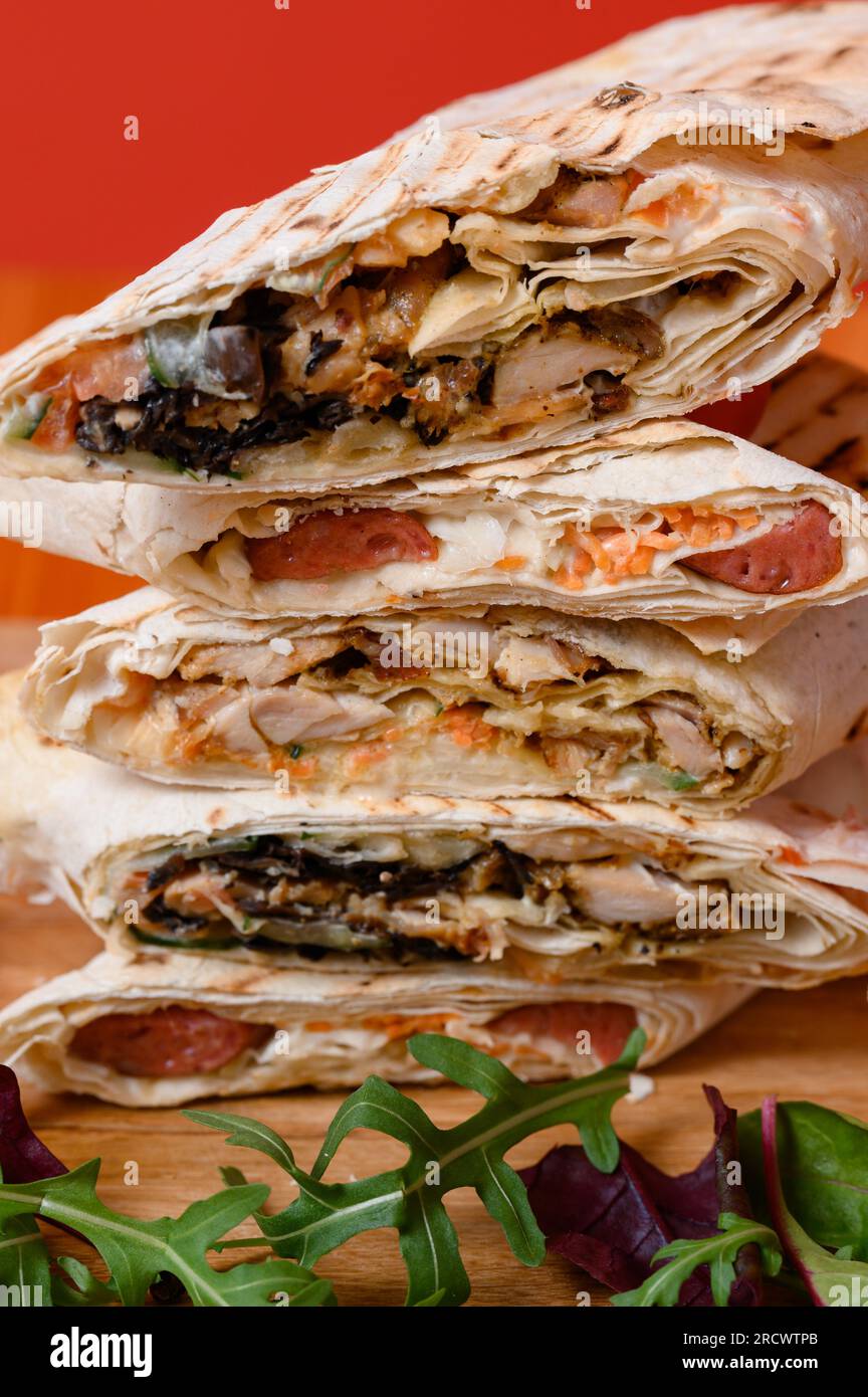 Three types of sliced shawarma stacked on top of each other, red ...