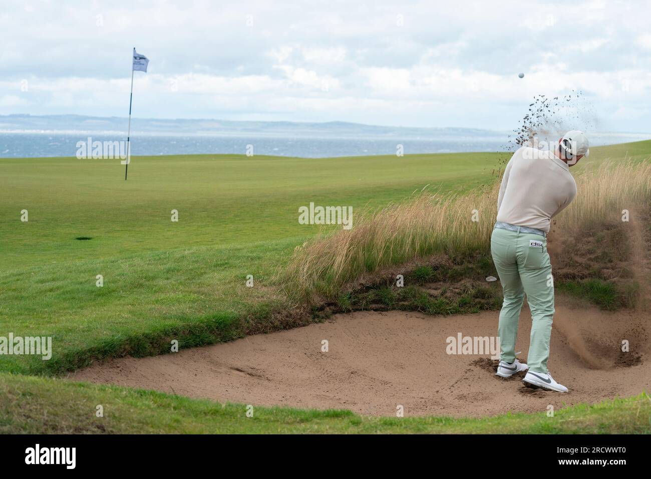 Rory McIlroy plays out of bunker on 12th hole during Genesis Scottish Open 2023 at the ...