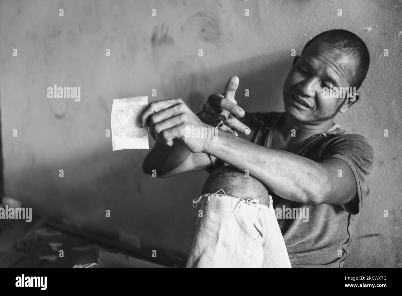 A heroin syringe in the hand of a drug addict. Drug concept ...