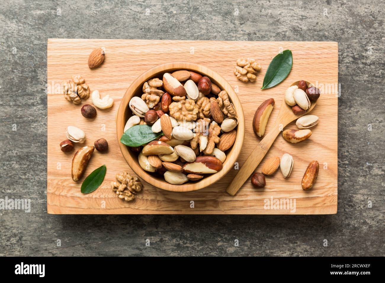 mixed nuts in bowl. Mix of various nuts on colored background ...