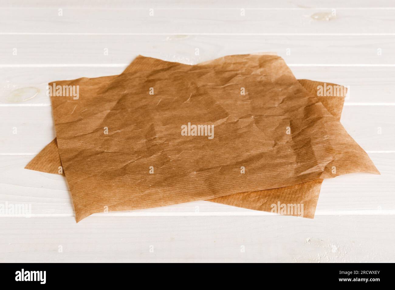 top view with baking parchment empty on table background. Folded cloth ...