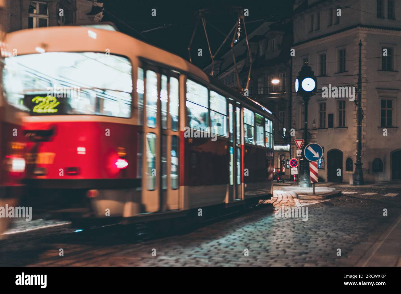 red tram in motion on city street at night Stock Photo - Alamy