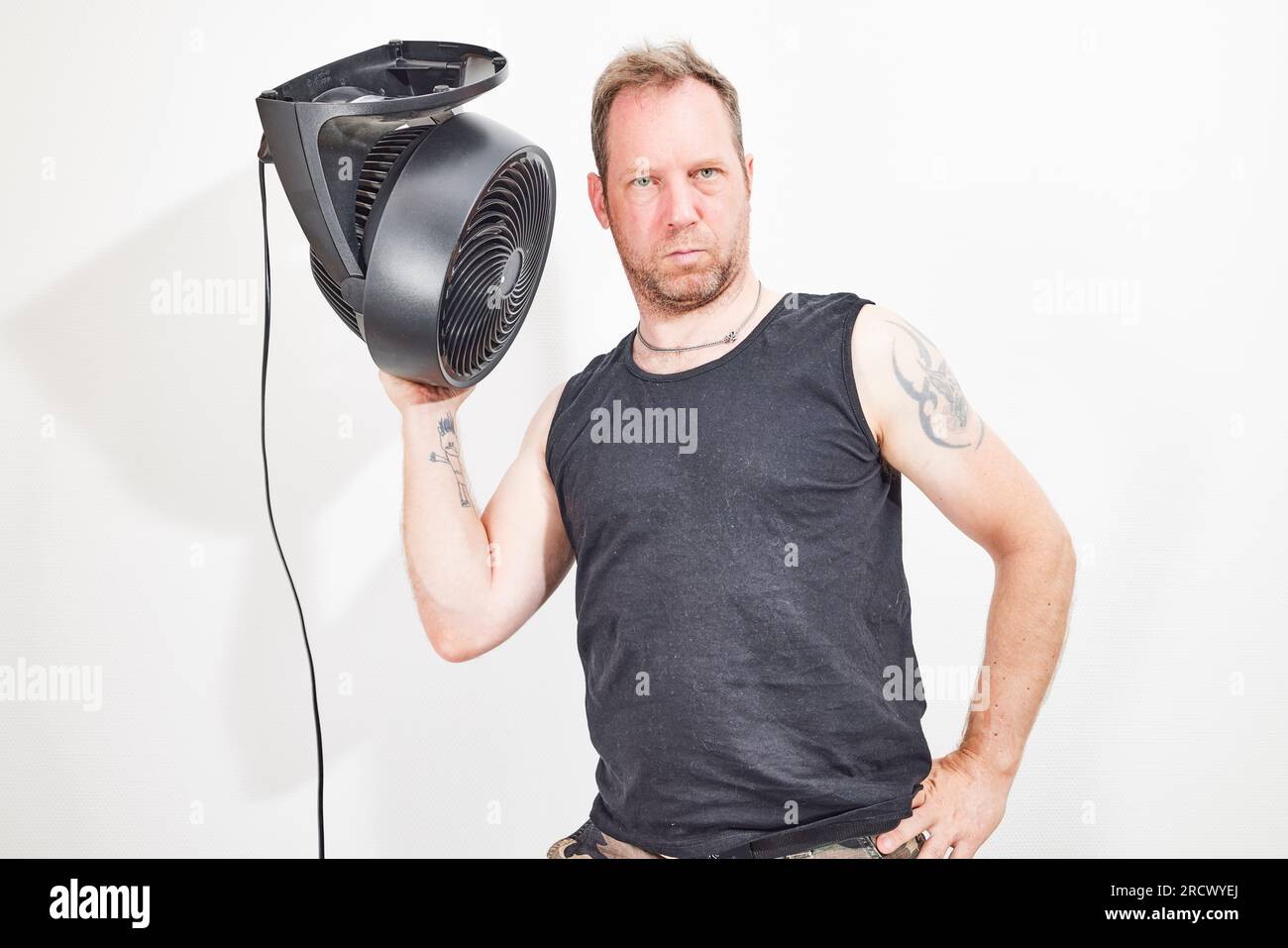 Man holding fan to cool the face Stock Photo - Alamy