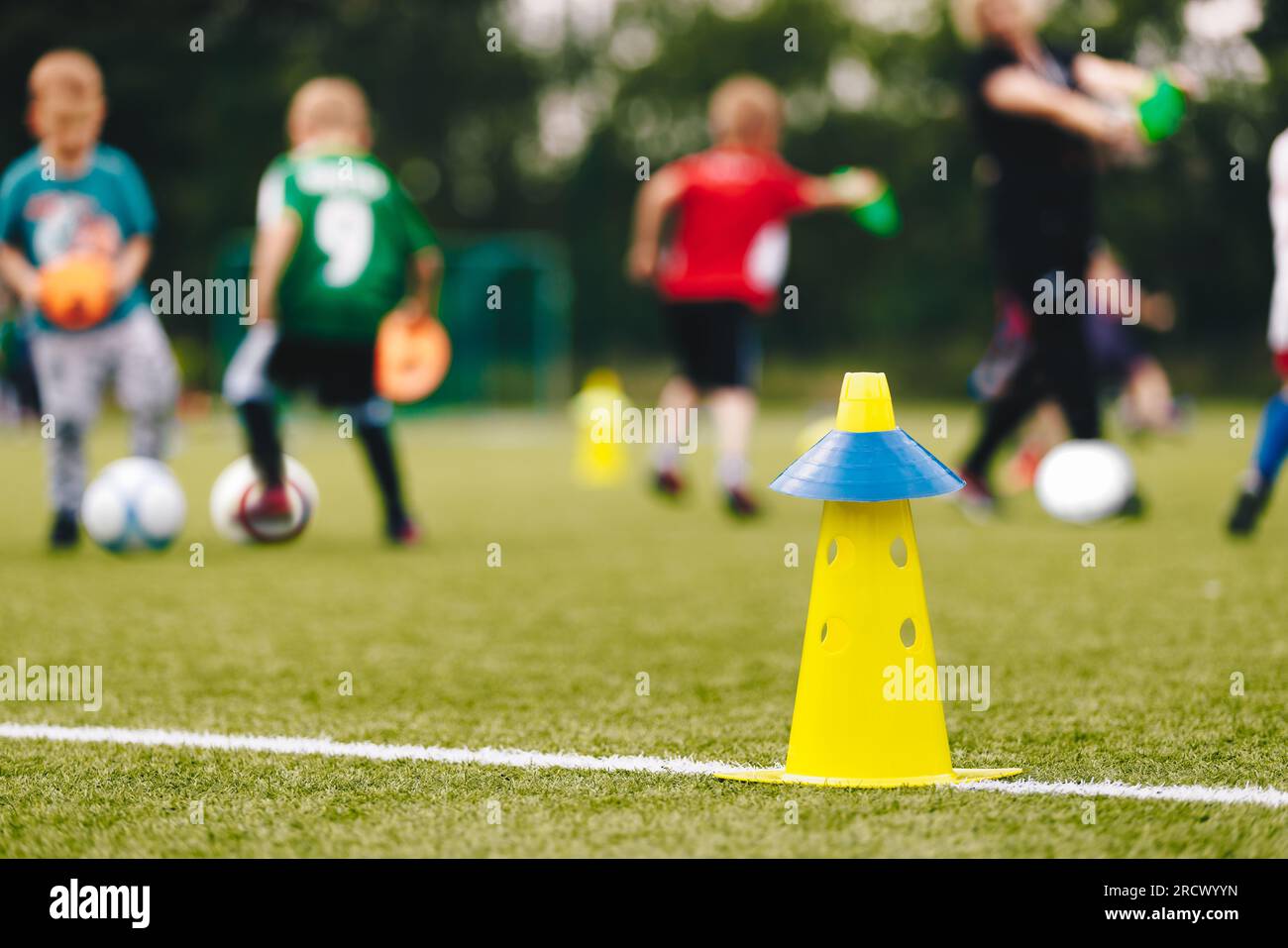 Little children having fun at soccer training drill with coach. Trainer ...