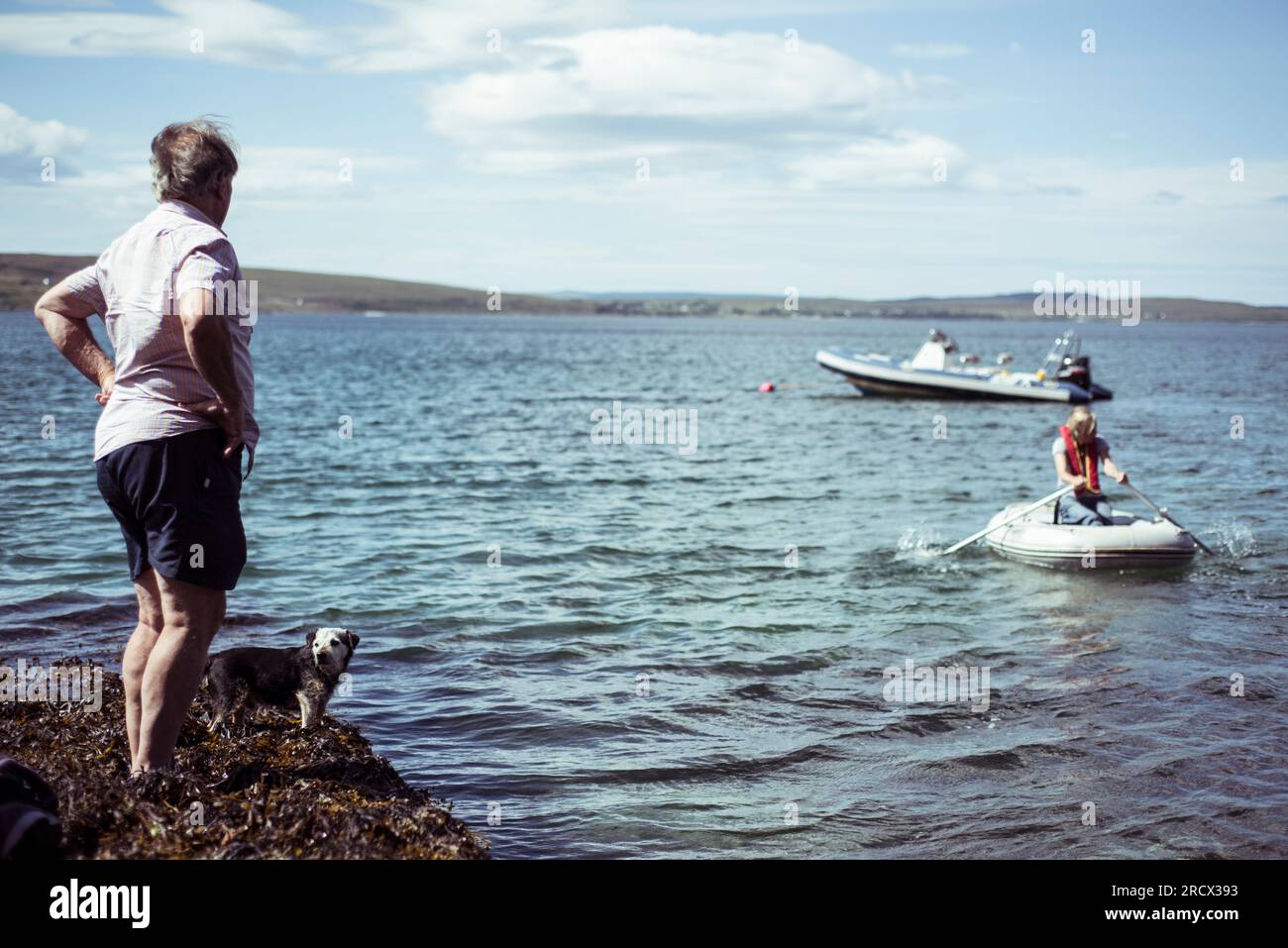Retired couple and dog row boat Stock Photo - Alamy