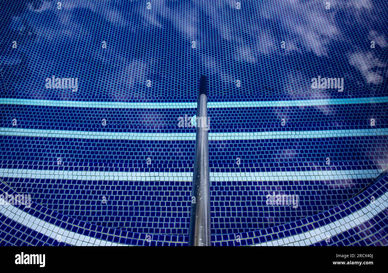 Cloud reflections in blue tiled swimming pool Stock Photo - Alamy