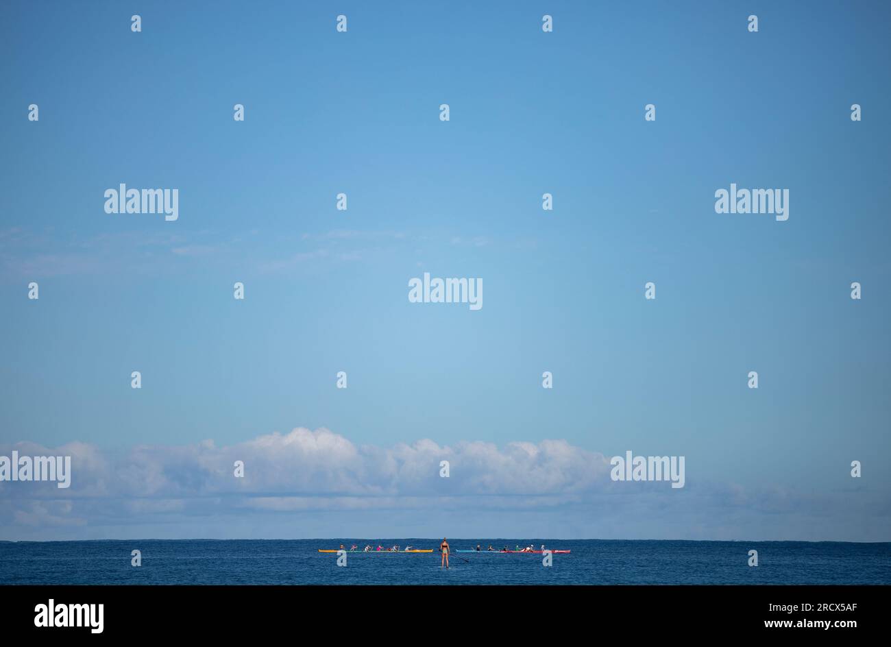 Paddle board in between outrigger canoes, Kauai Stock Photo - Alamy
