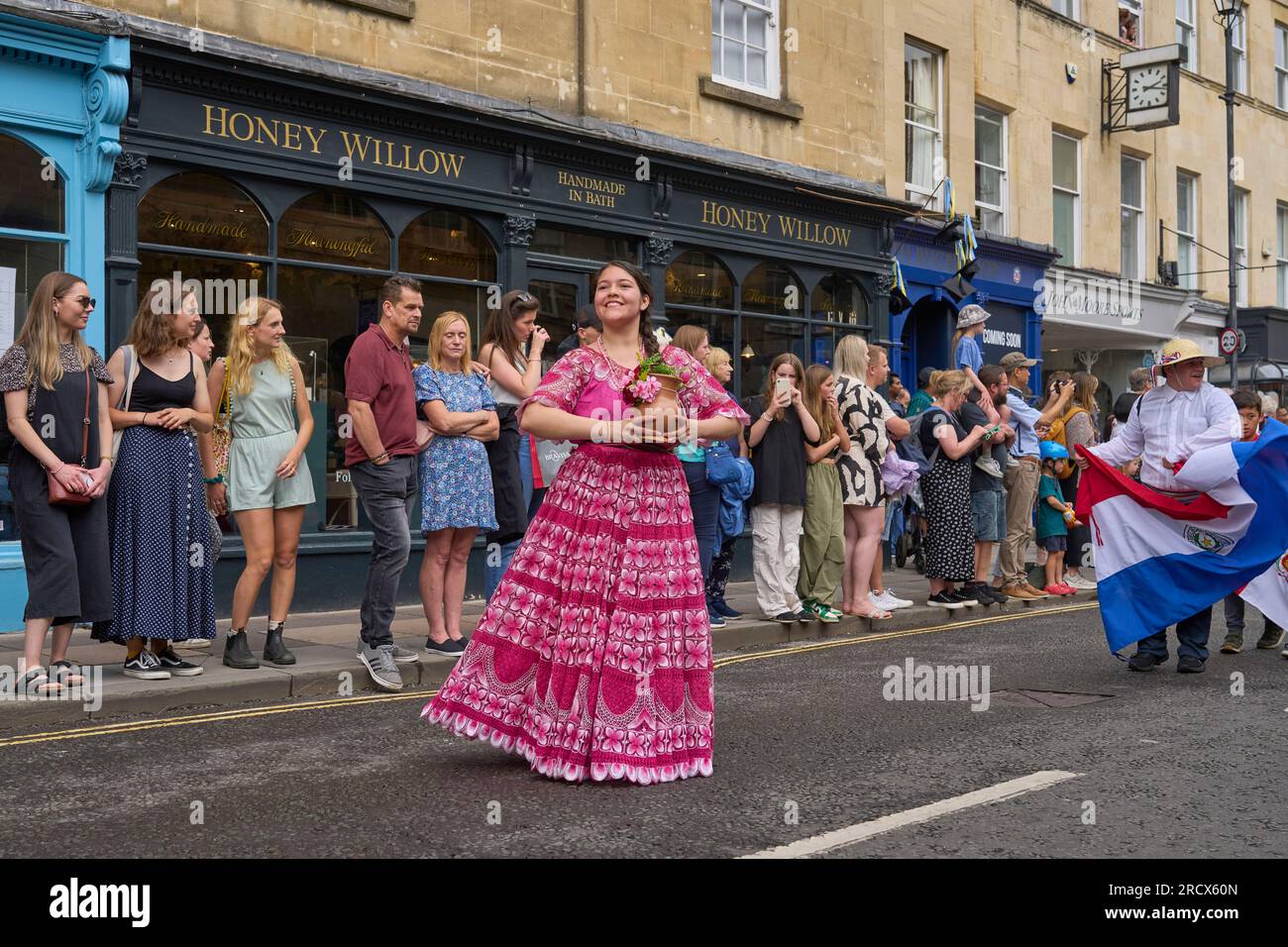 Dancers and musicians dressed in ornate costumes parade through the ...
