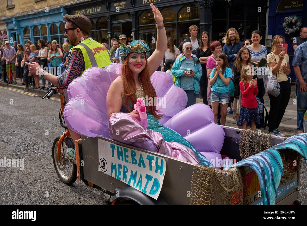 Dancers and musicians dressed in ornate costumes parade through the ...