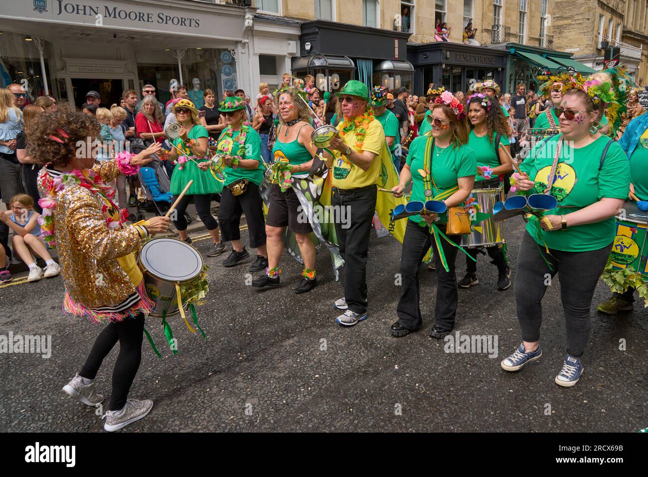Dancers and musicians dressed in ornate costumes parade through the ...