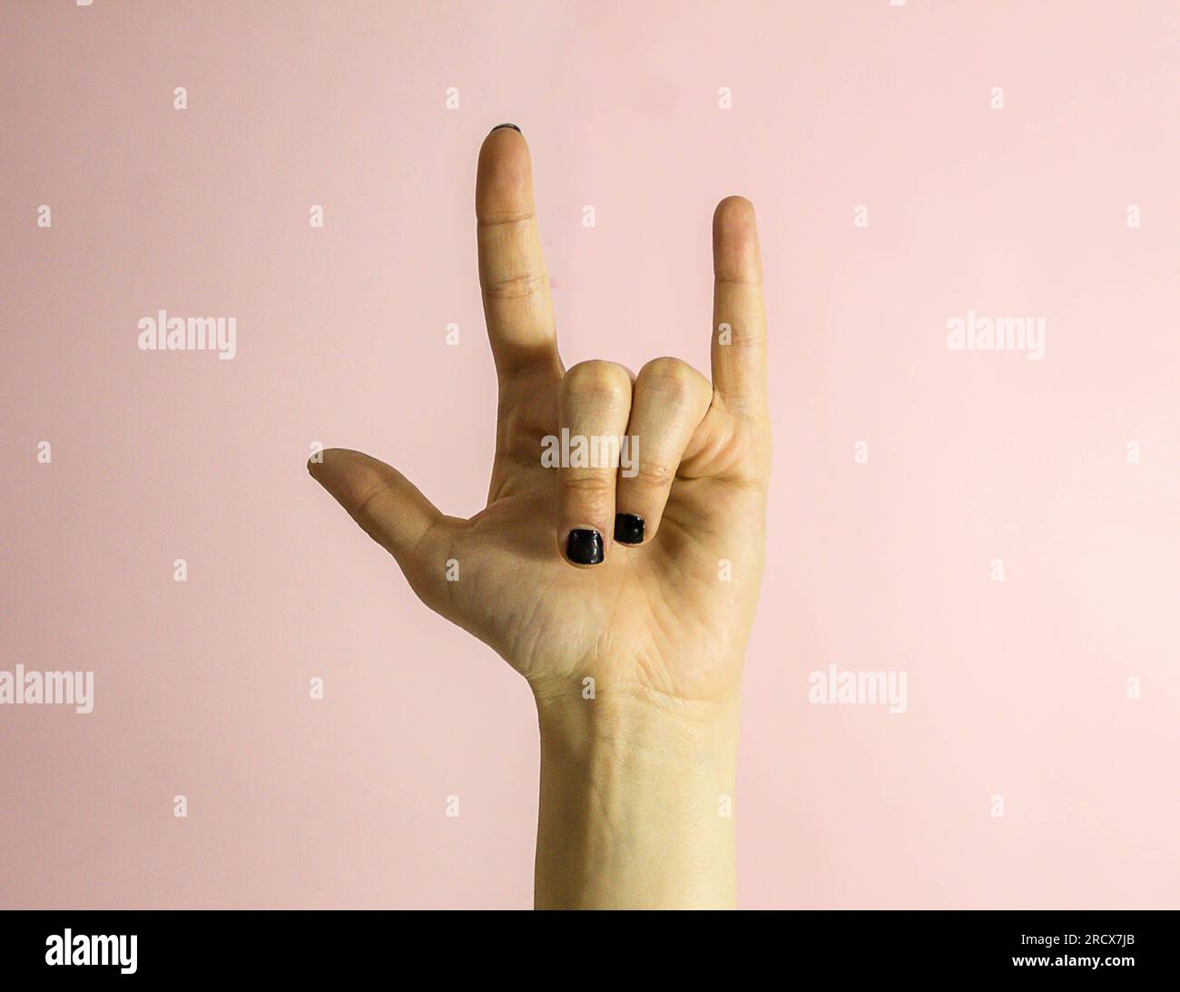 Rocker symbol, woman's hand Stock Photo - Alamy