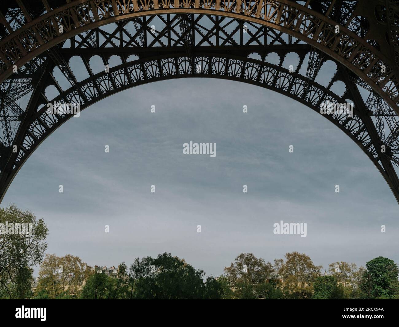 Stunning view through the bottom arch of the Eiffel Tower Stock Photo ...