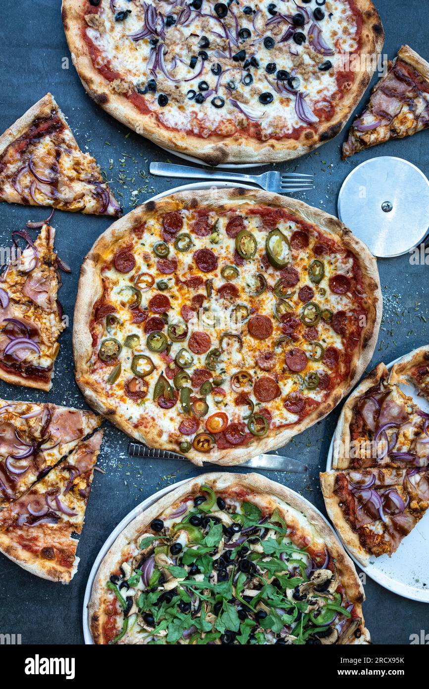 Pizza dinner. Flat lay of various types of Italian pizza on rustic ...