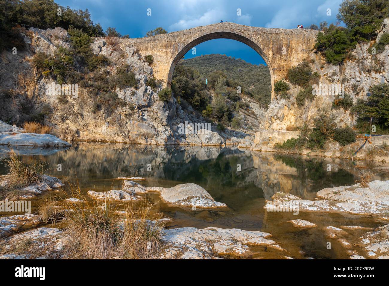 View of an ancient bridge Pont de Llierca in Catalonia, Spain. This ...