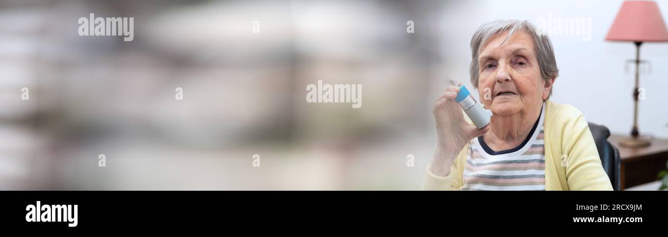 Elderly woman using an asthma inhaler; panoramic banner Stock Photo - Alamy