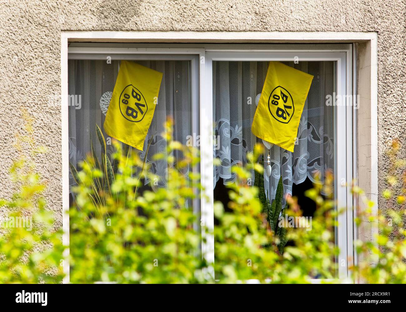 flags of Borussia Dortmund in the window of a residential building ...