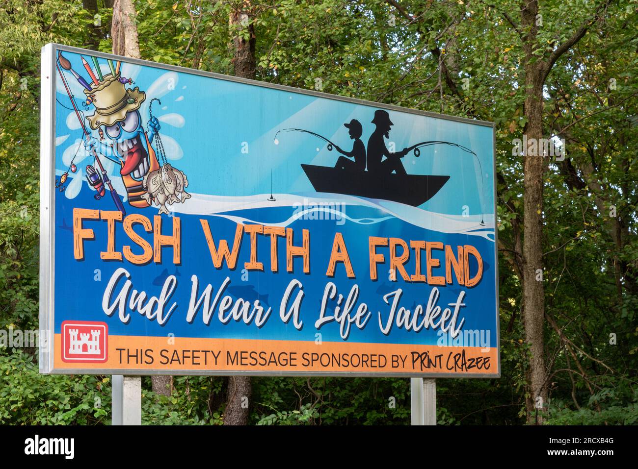 A post sign cautions fishermen to fish with friends and wear a life ...