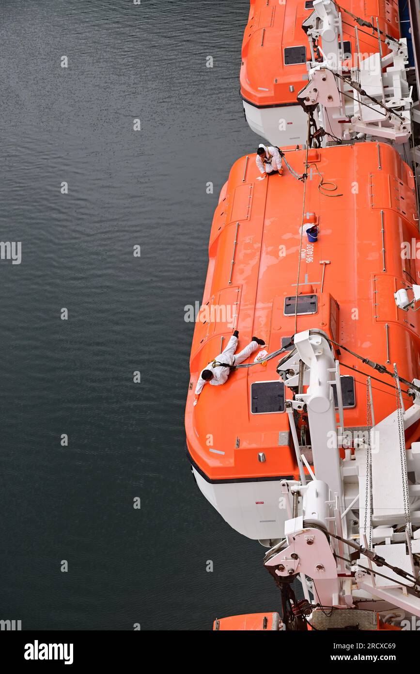 Routine maintenance being carried out on one of the lifeboats (tenders ...